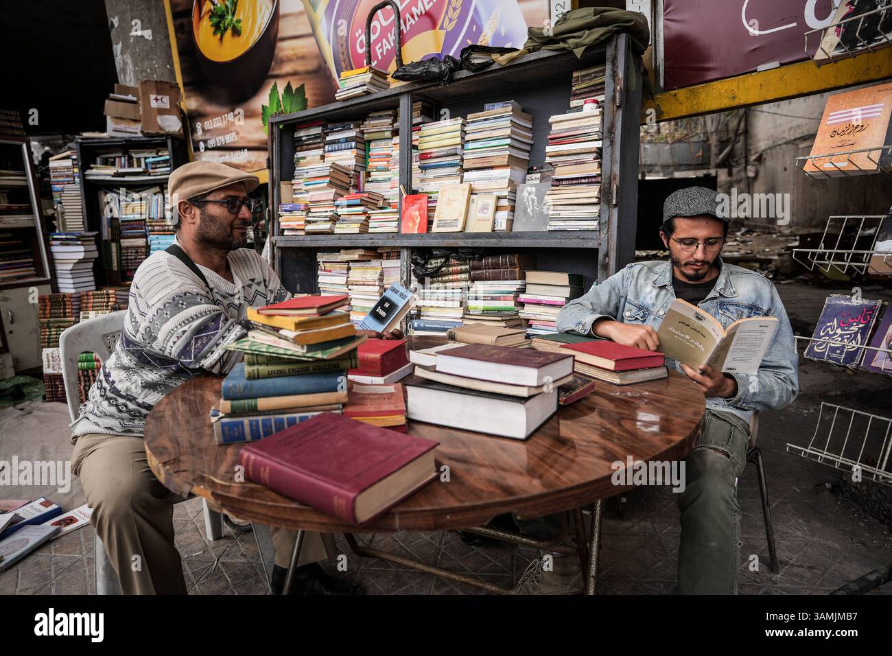 Damascus, Syria. 18th Mar, 2025. Syrian book vendors Adallah Hamdan (L ...