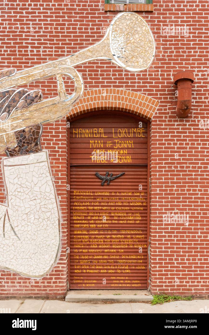 Mosaic mural on brick wall and words painted on door, a tribute to ...