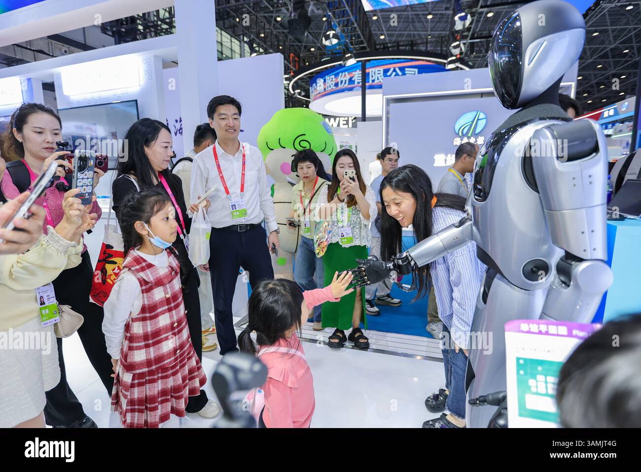 A child touches hand of a humanoid robot during the 5th China ...