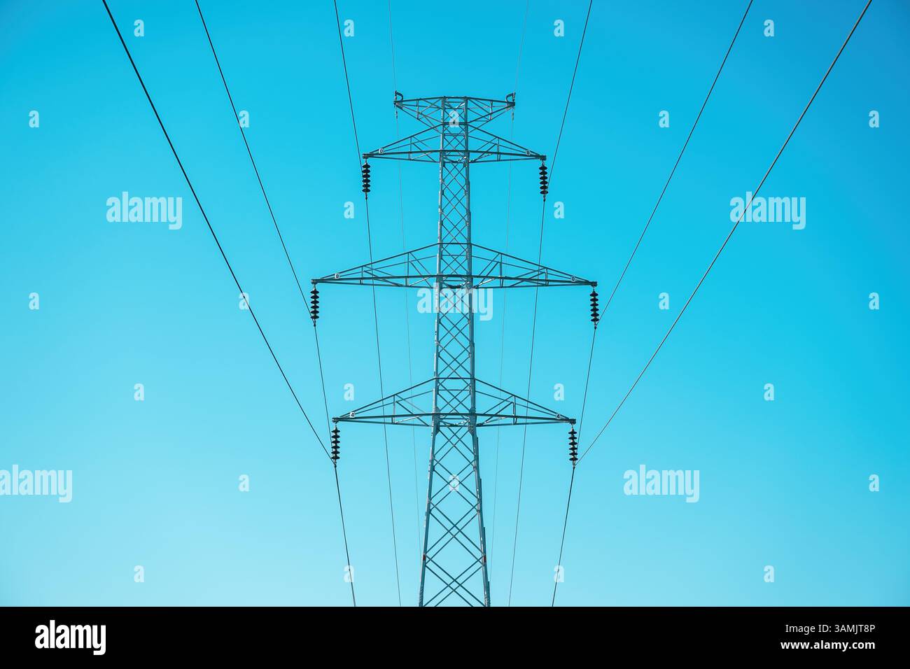 Electricity pylon with overhead powerline cables against cloudy sky ...