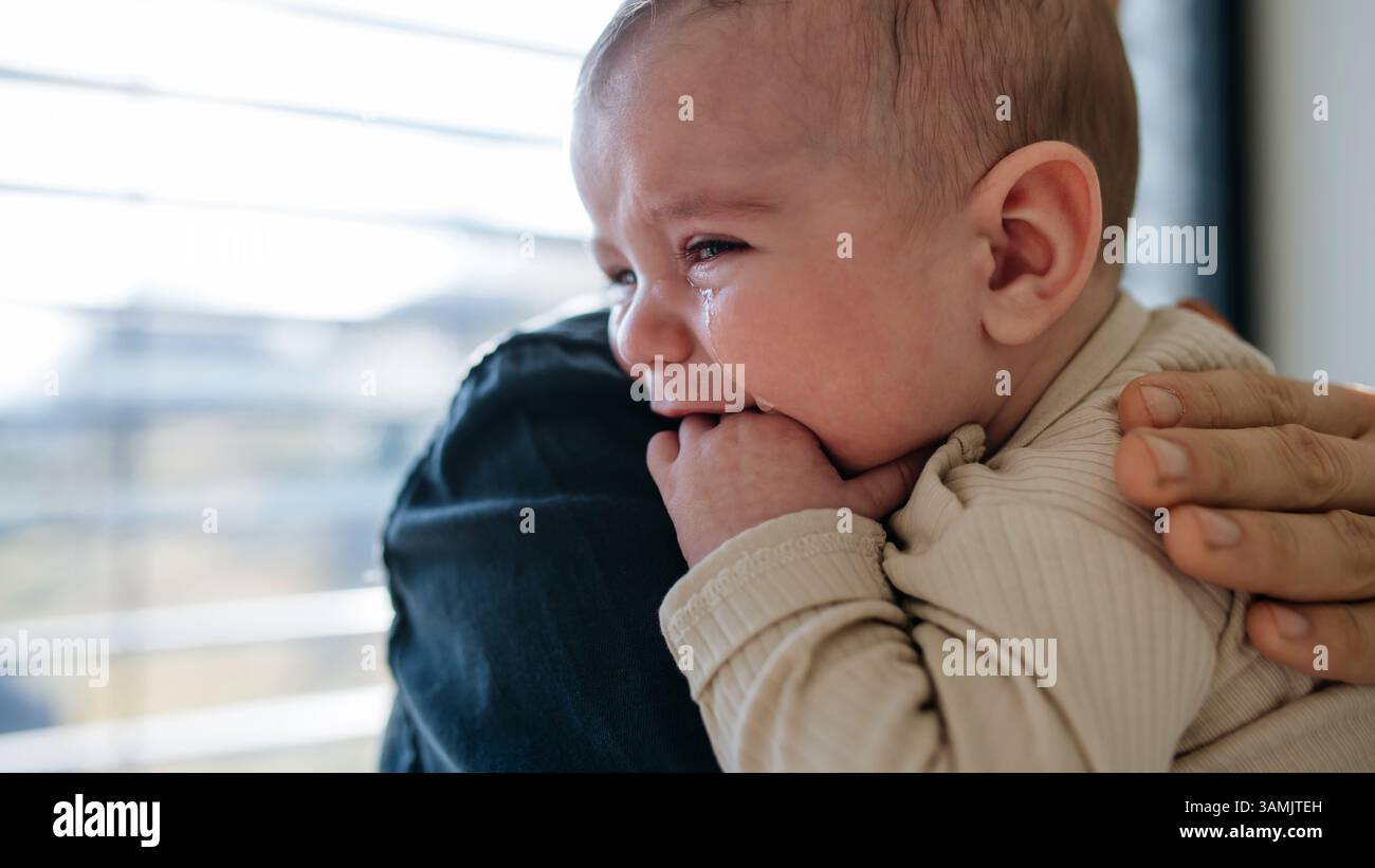Father comforting his crying baby son Stock Photo - Alamy