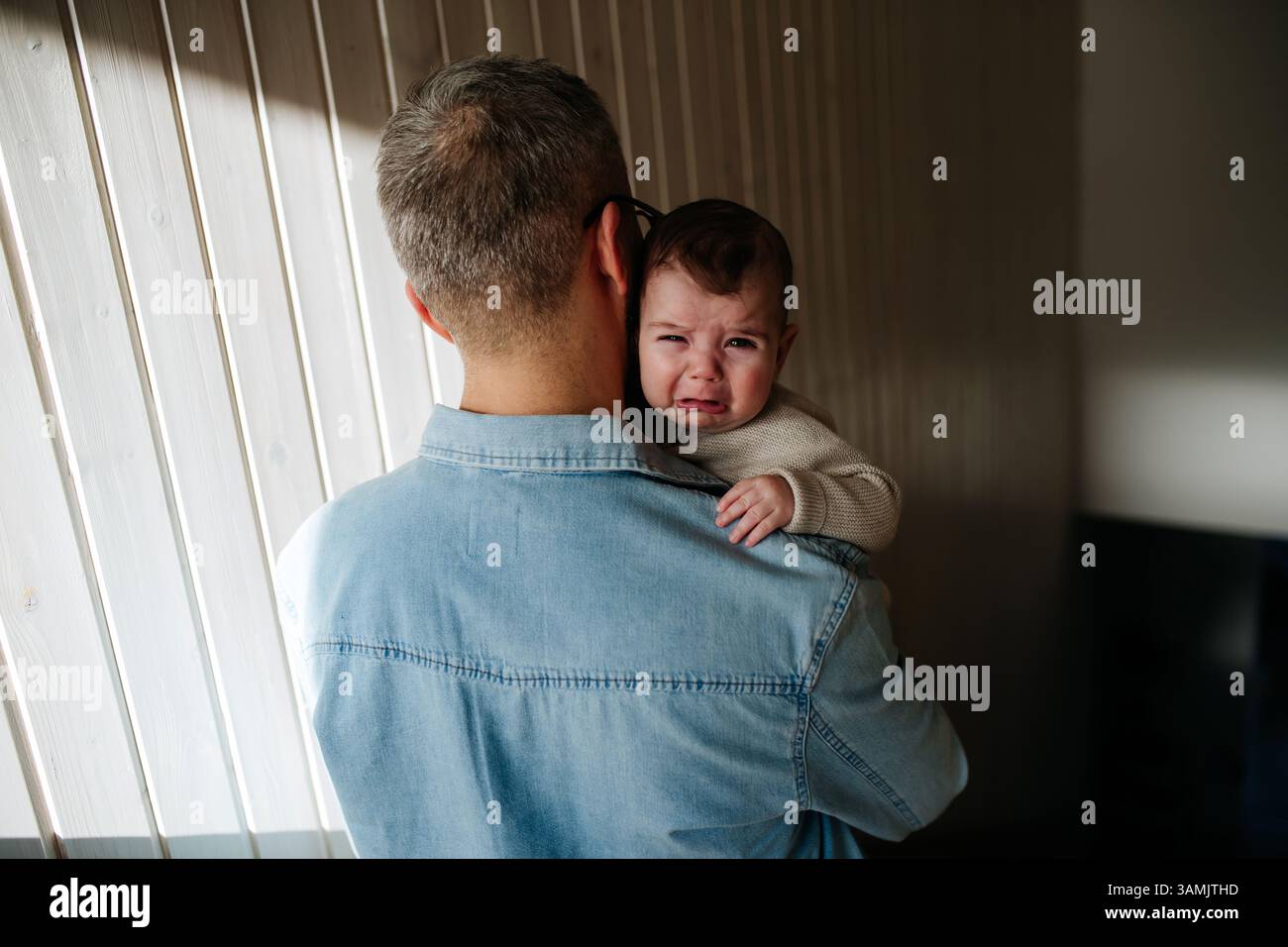 Father comforting his crying baby son Stock Photo - Alamy