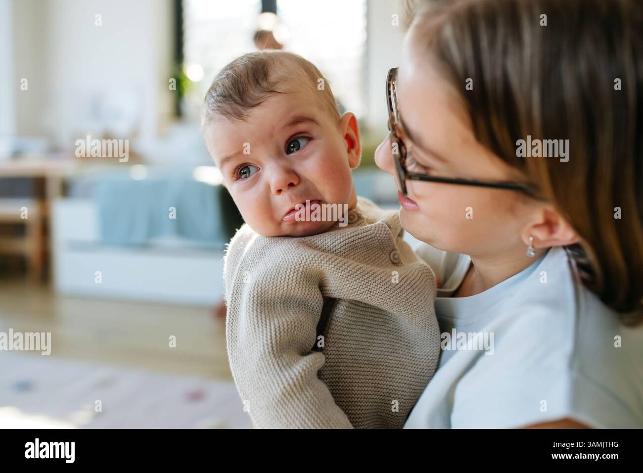 Big sister comforting crying baby brother Stock Photo - Alamy