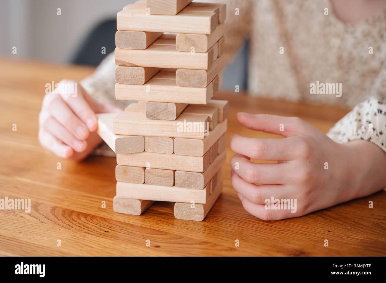 children playing educational board game at home in kitchen, girl ...