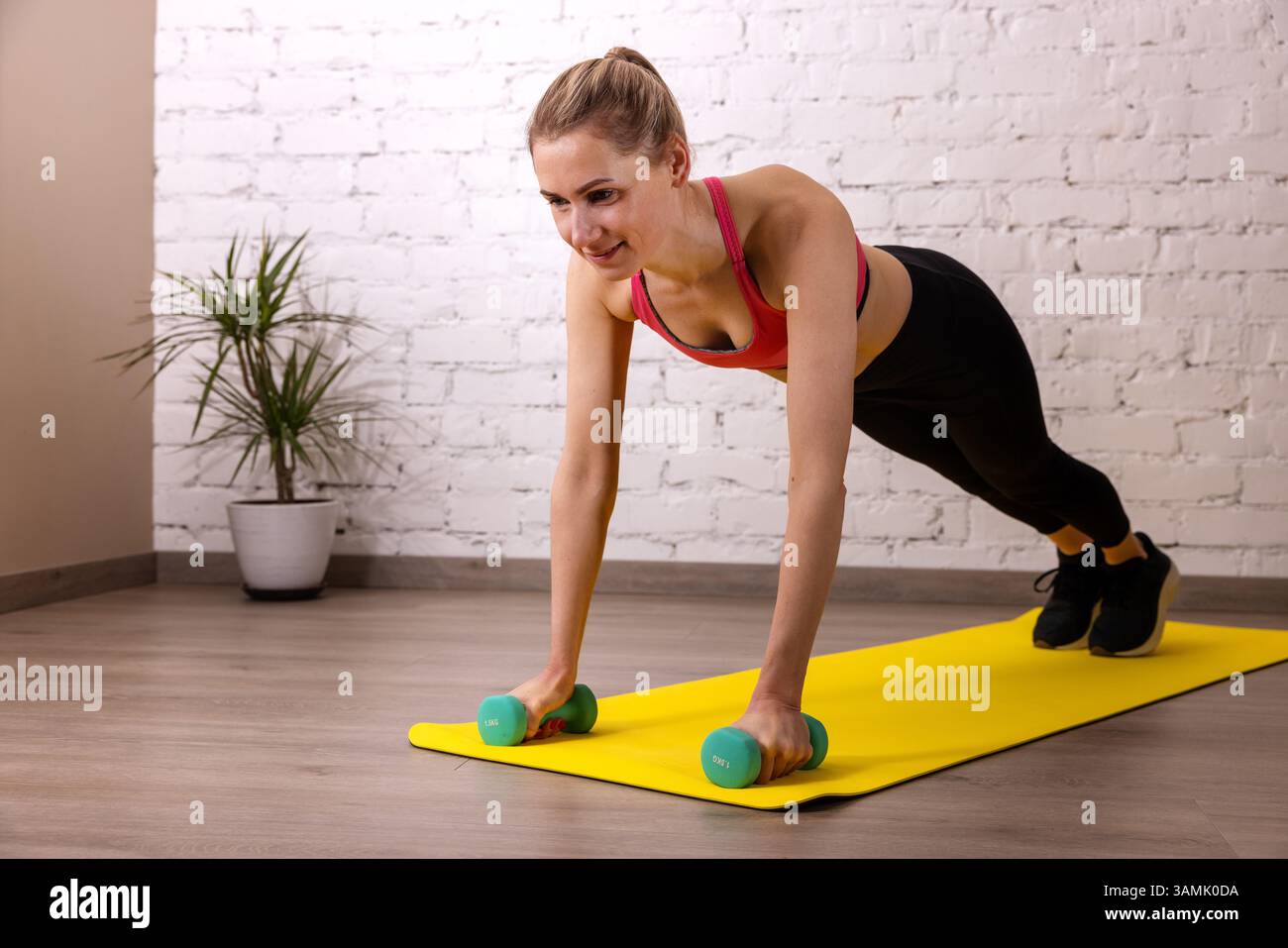 fitness woman doing dumbbell pushups in the gym Stock Photo - Alamy