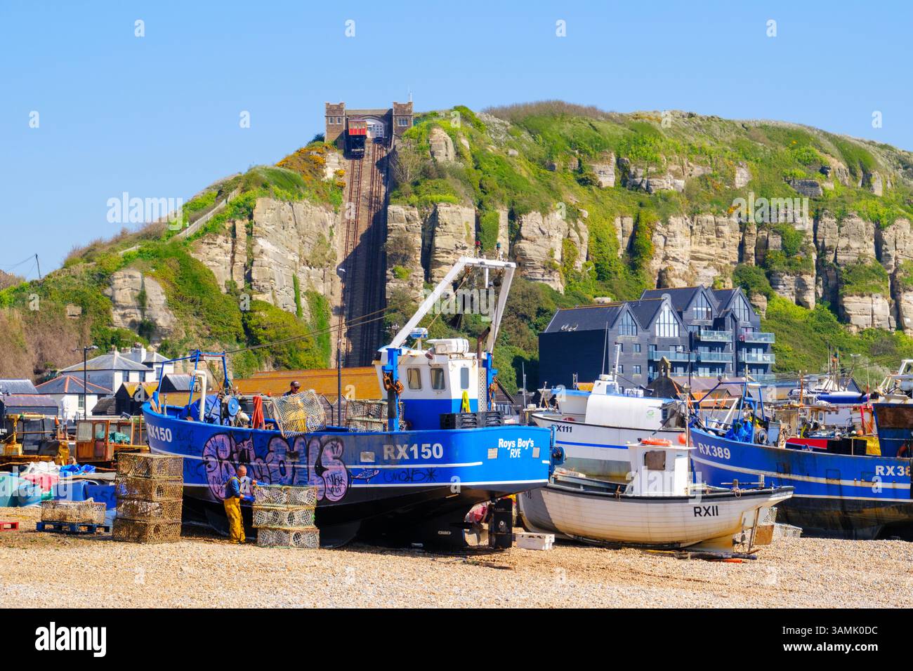 Hastings fishermen loading cuttlefish nets on trawler, on the Old Town ...