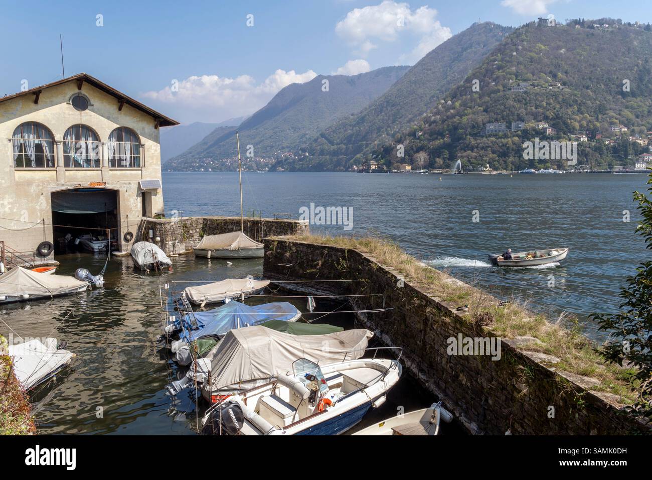 Como, Italy - April 4, 2025: A boathouse along the shore of lake Como ...