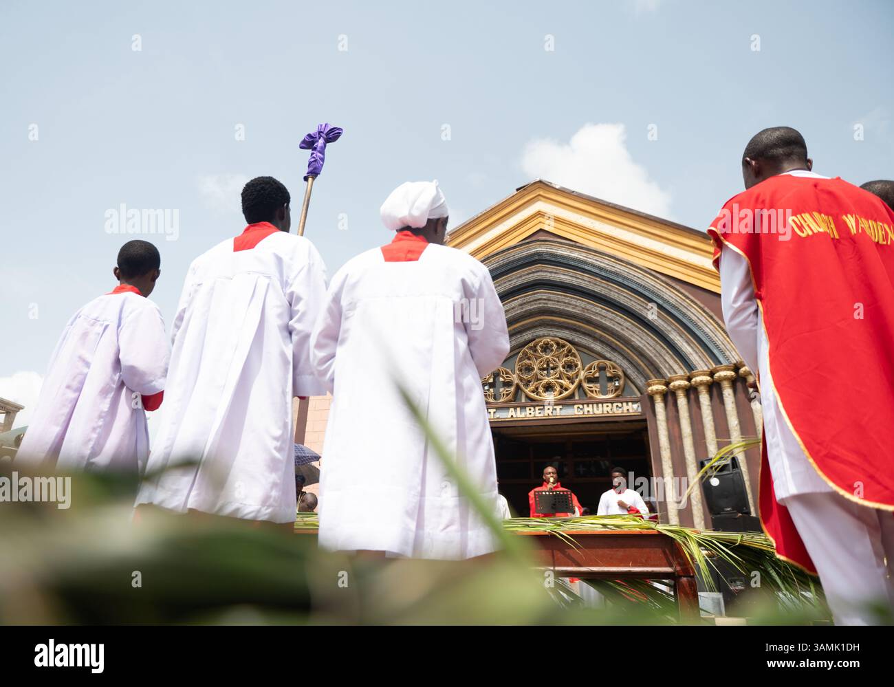 Priest prays for church worshipper during the Palm Sunday special ...