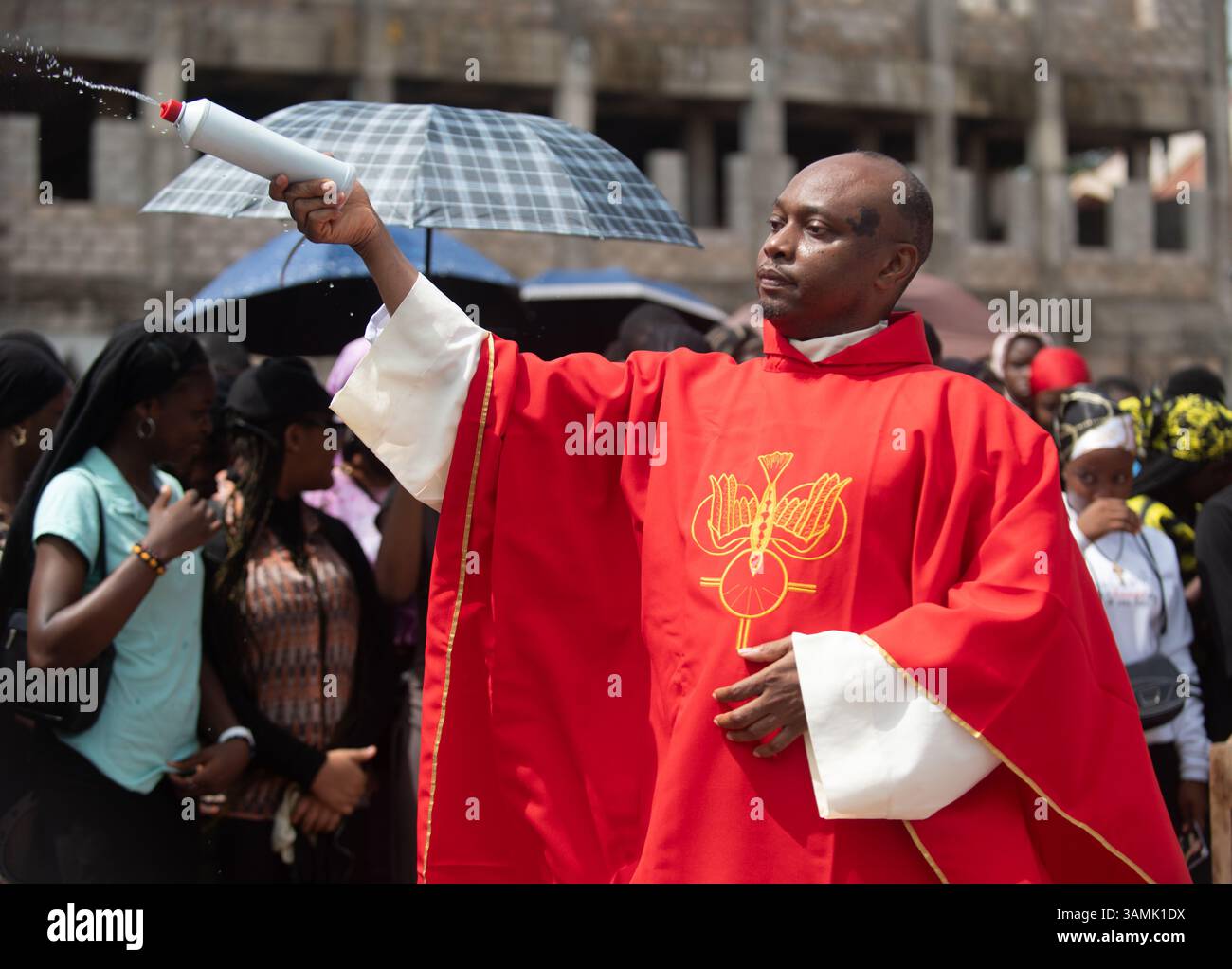 Priest prays for church worshipper during the Palm Sunday special ...