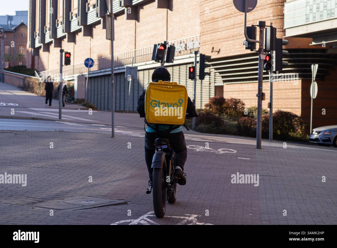 Poznan, Poland - April 8, 2025: Courier with bright yellow Glovo ...