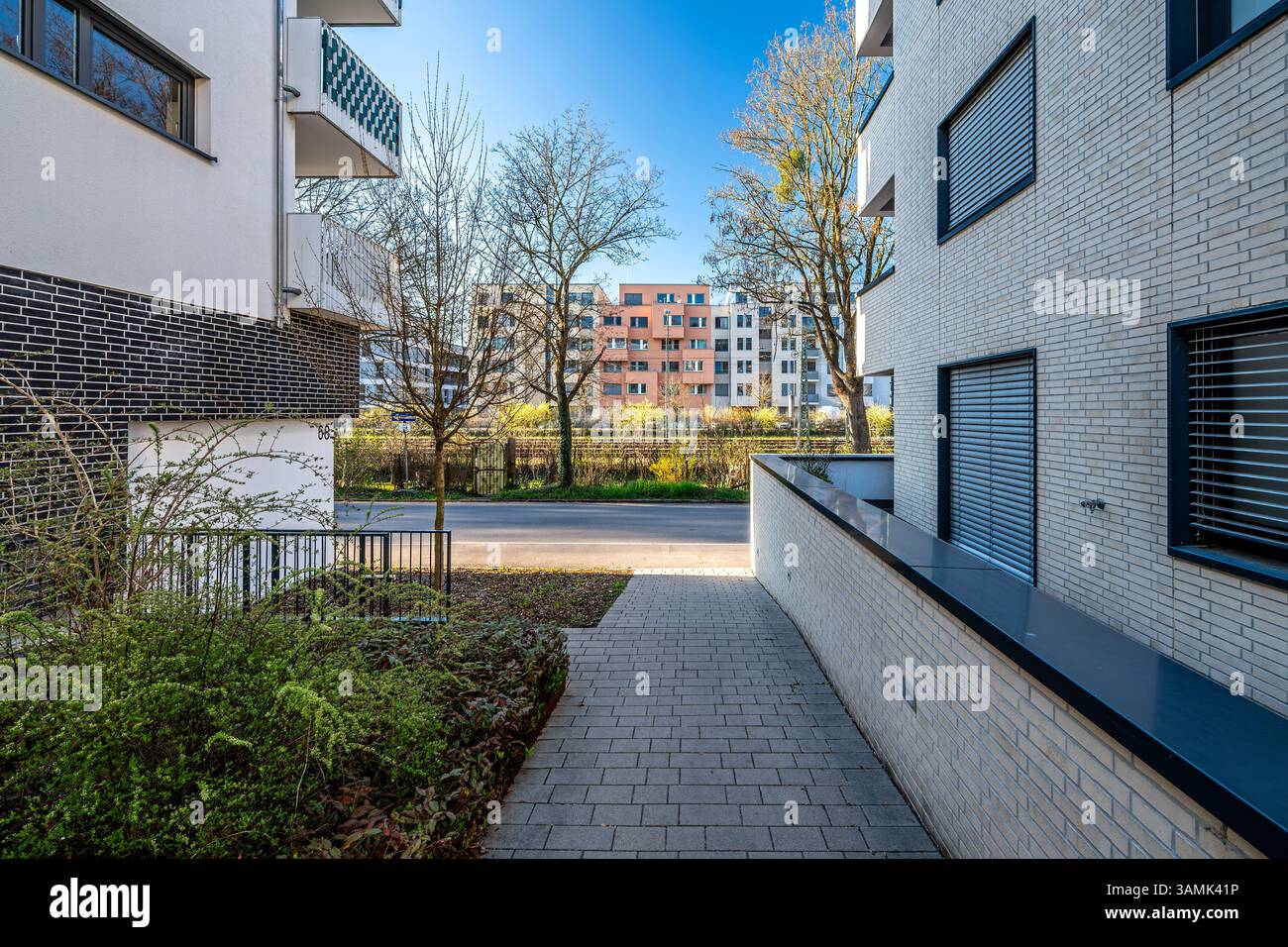 Pedestrian path between modern residential buildings in newly built ...