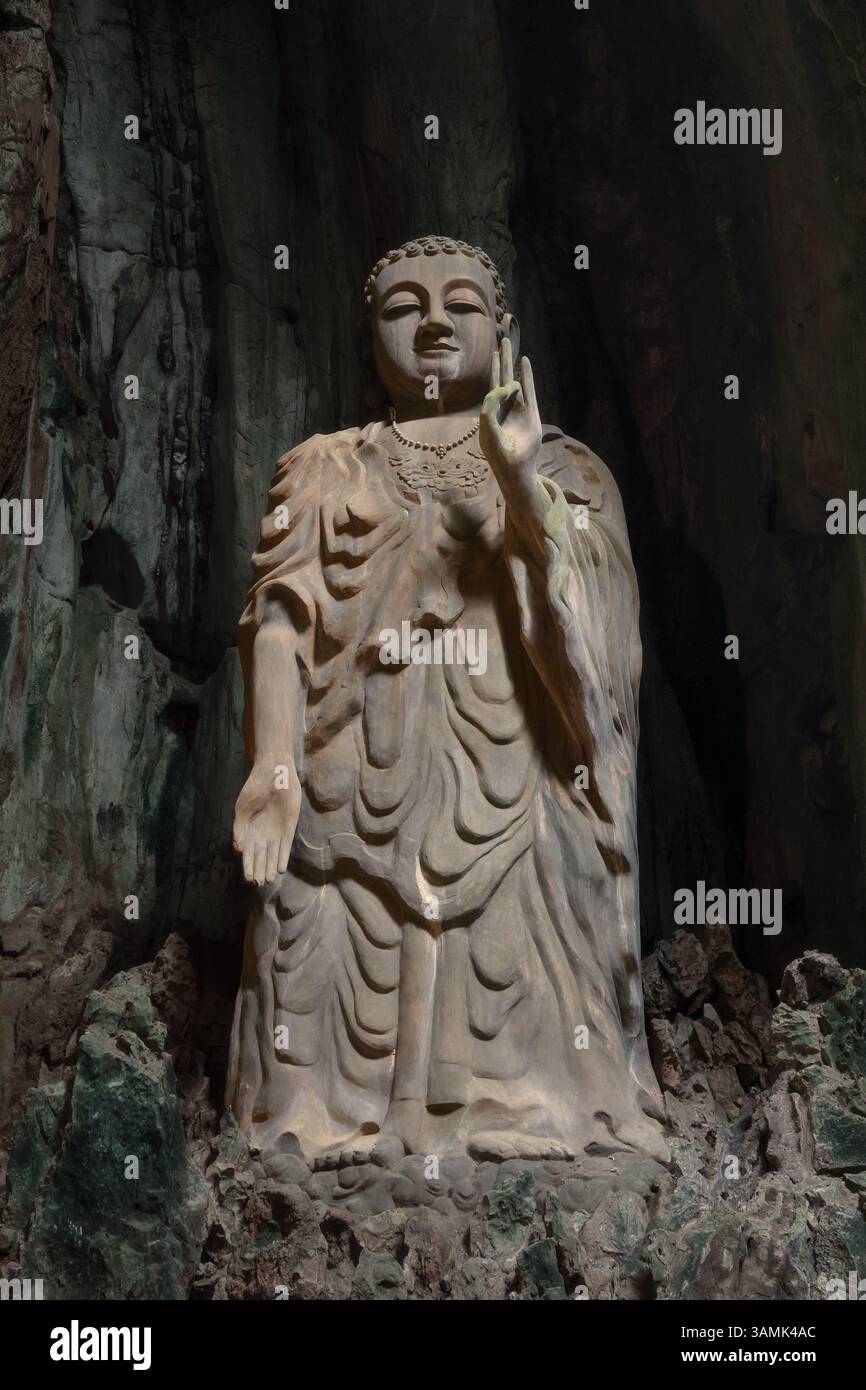 Standing Buddha statue inside the caves of the Marble mountains Stock ...