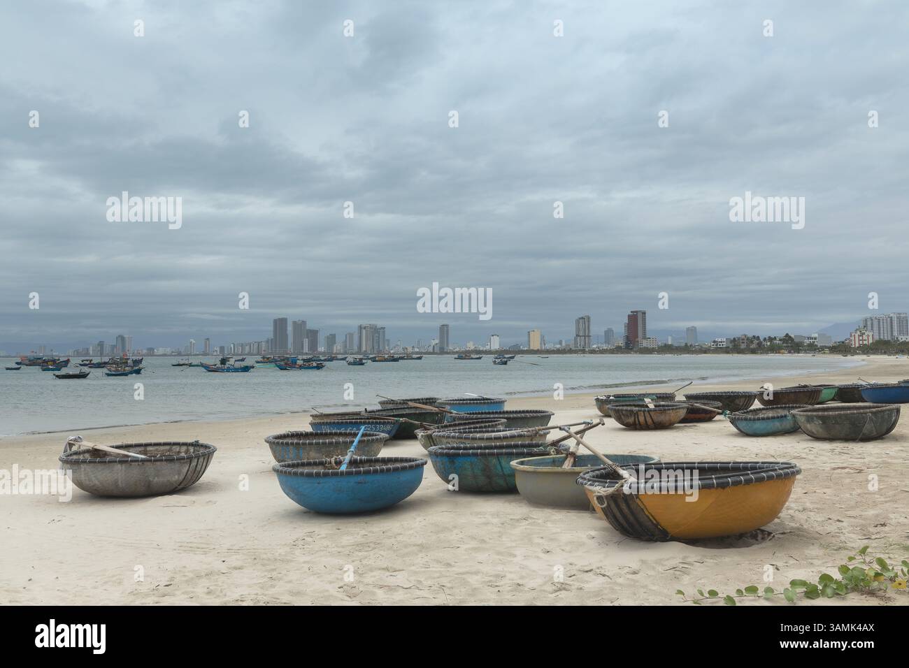 Basket boats, fishing vessels and urban skyline at the scenic coast of ...