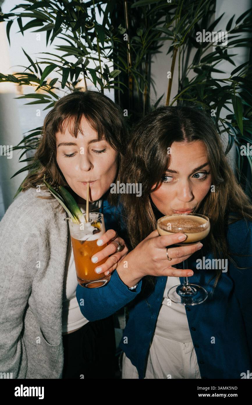 Person holding straw two cocktails hi-res stock photography and images ...