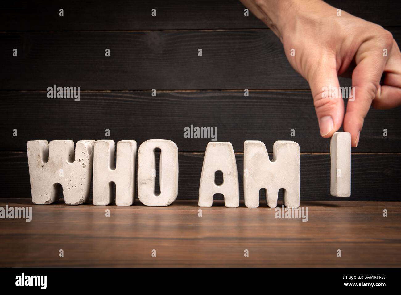 Hand Placing WHO AM I Text on Wooden Desk Stock Photo - Alamy