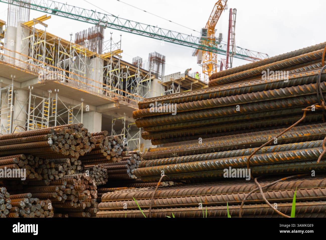Steel rods stacked together at a construction site, with construction ...