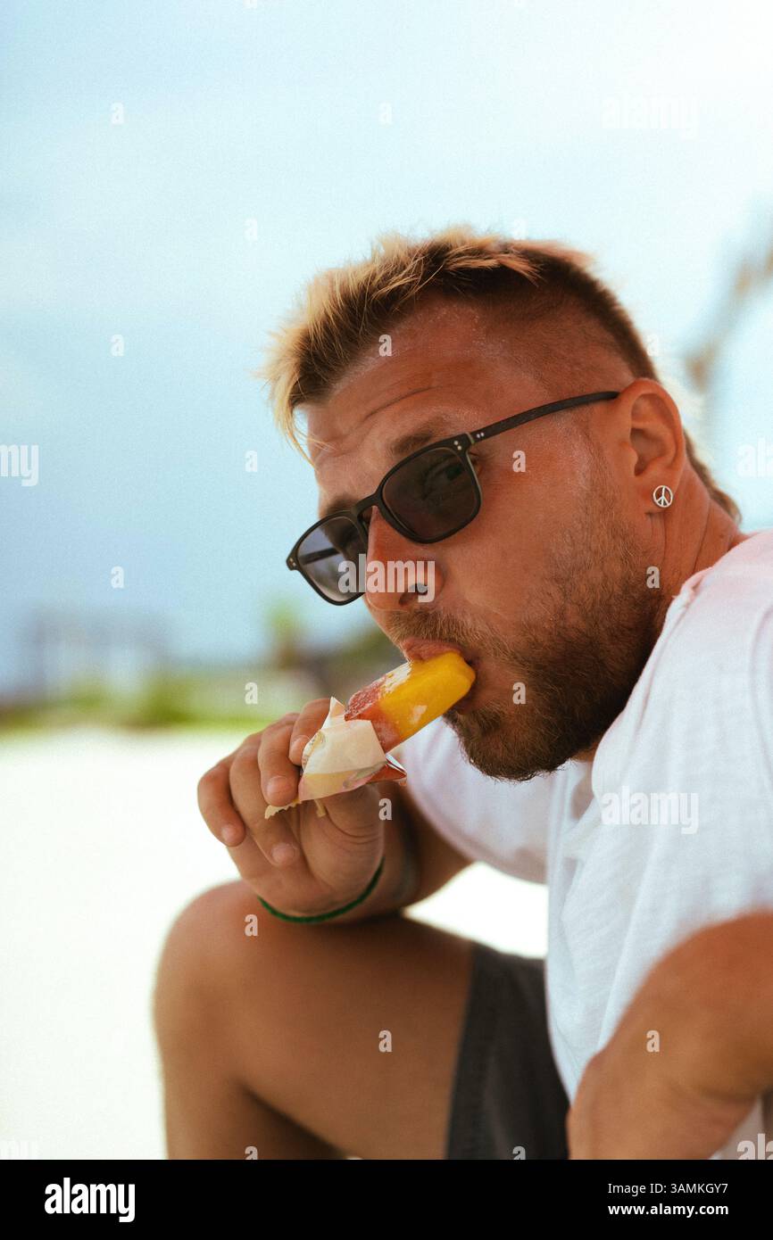 Man eating ice cream in the beach Stock Photo - Alamy