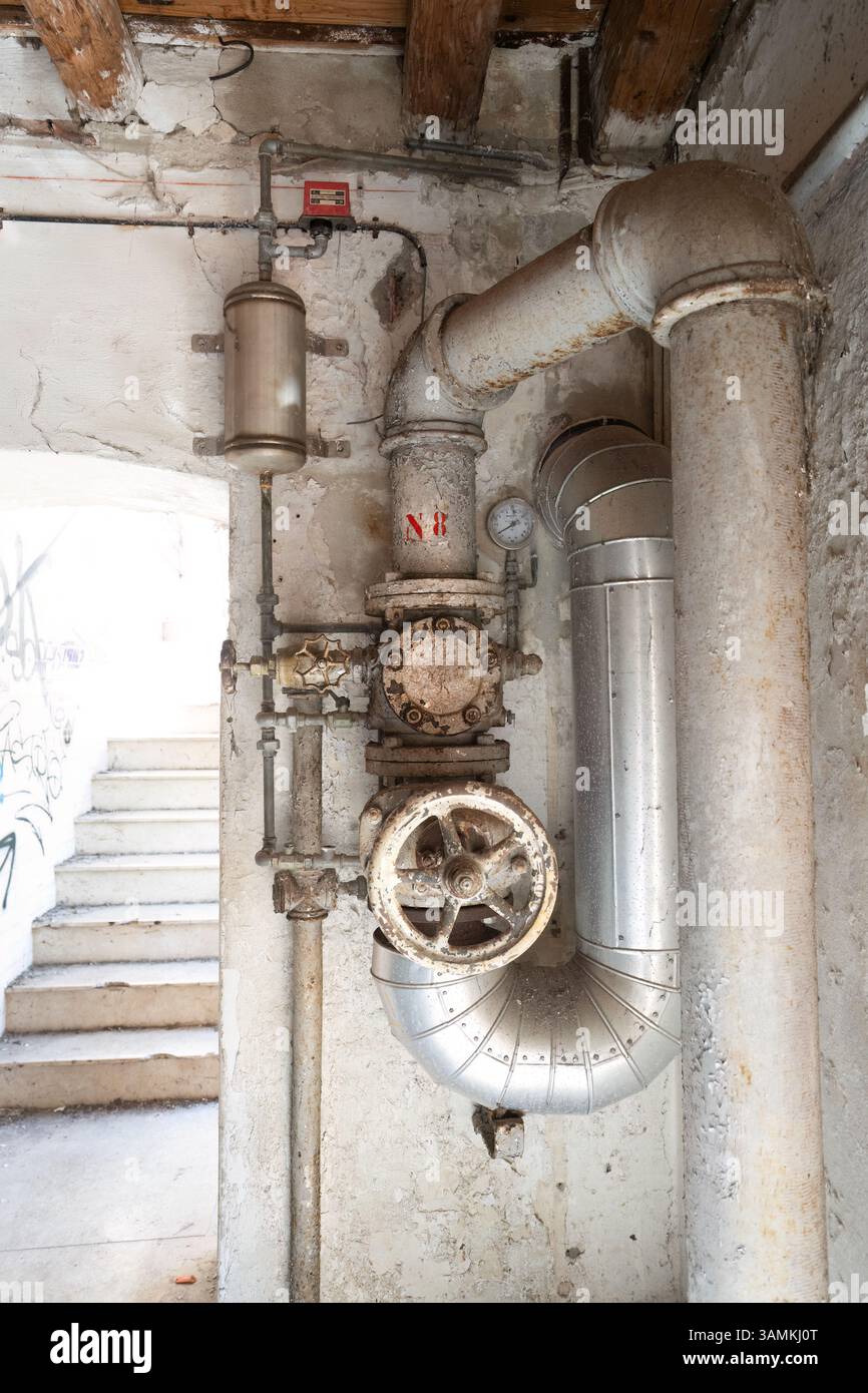 old pipes with measuring and control instruments in an abandoned ...