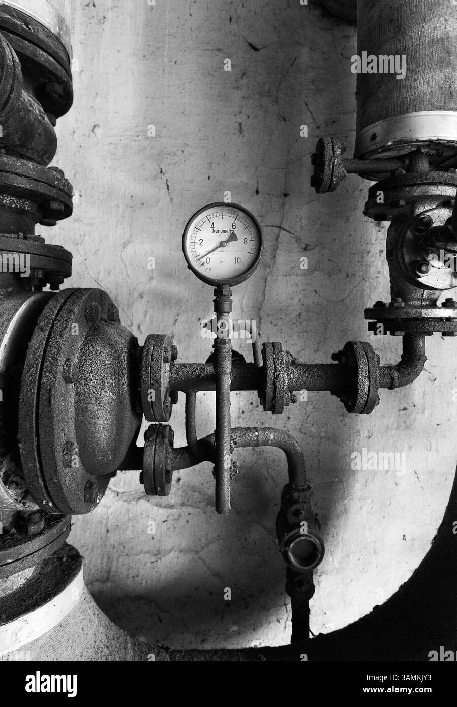old pipes with measuring and control instruments in an abandoned ...
