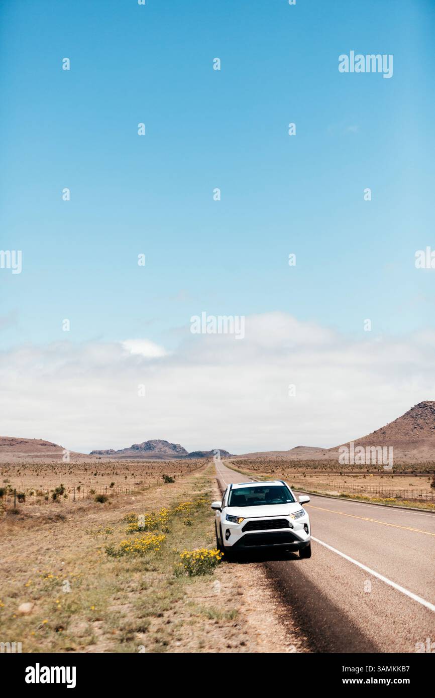 White SUV parked on roadside in vast West Texas desert landscape Stock ...
