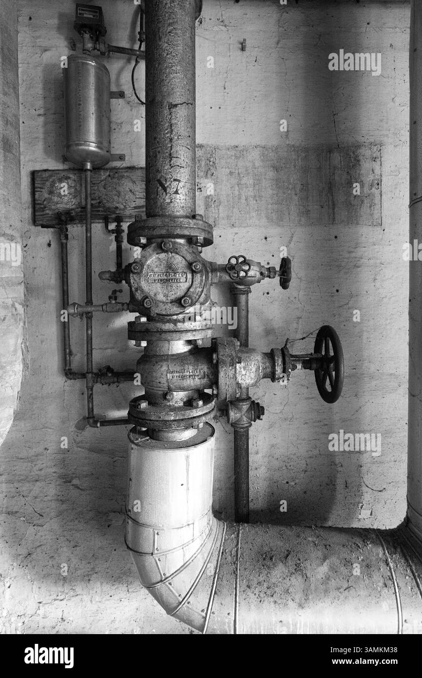 old pipes with measuring and control instruments in an abandoned ...
