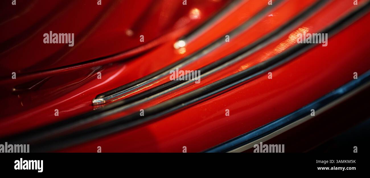 Curved details of a vibrant red surface illuminated by soft light Stock ...