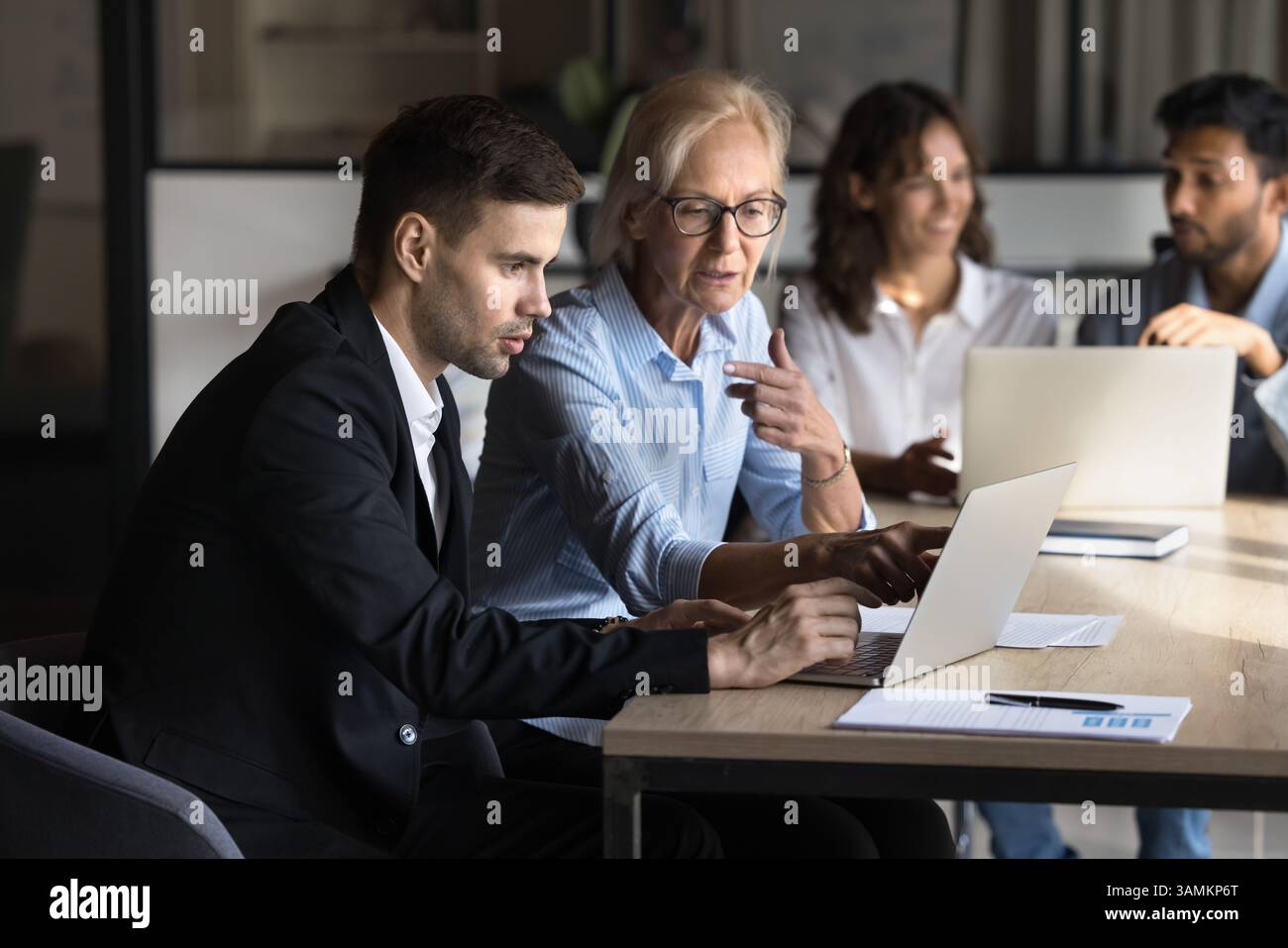 Two diverse corporate professionals teamwork with laptop Stock Photo ...