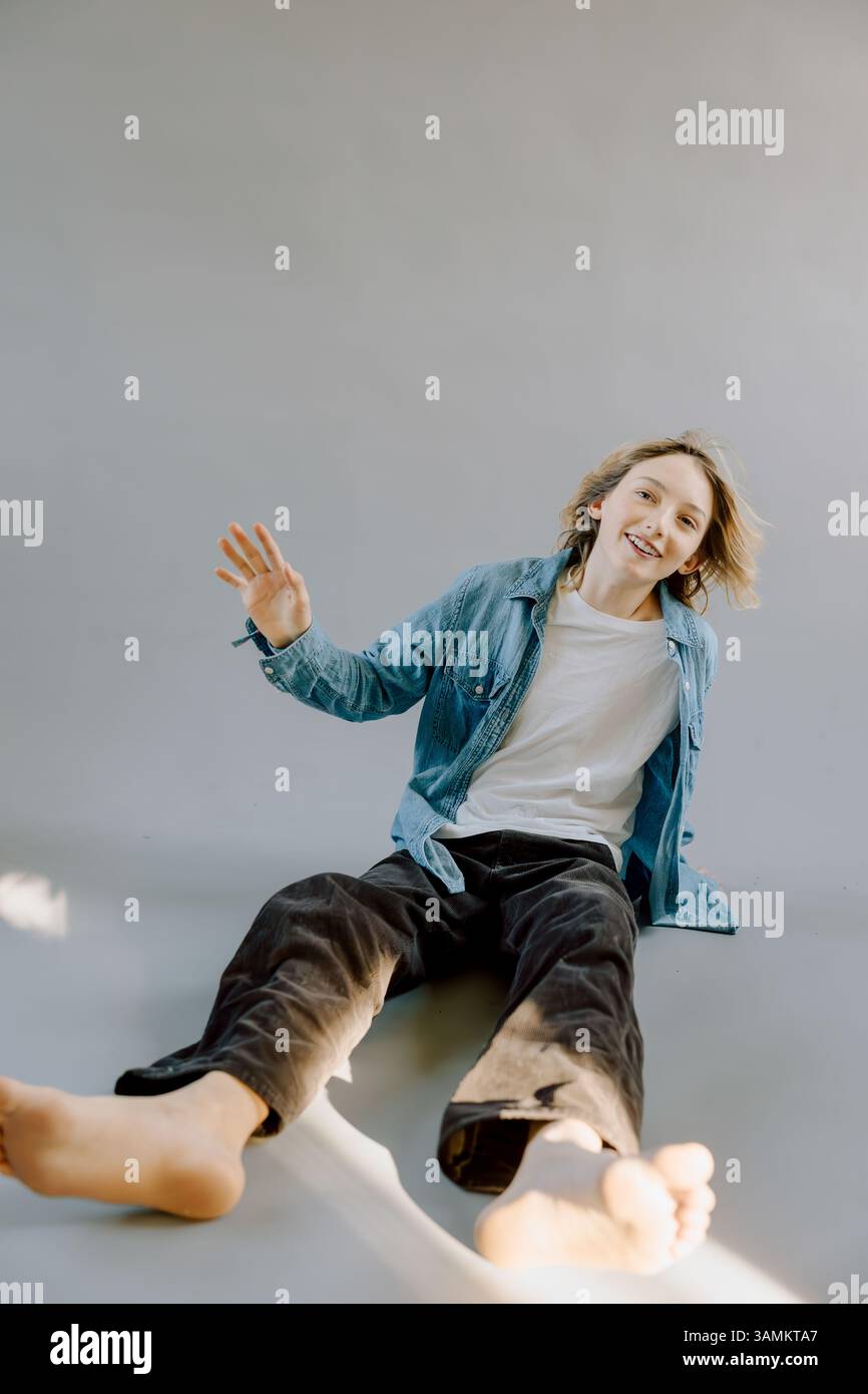 Boy with tousled hair poses with laid-back attitude Stock Photo - Alamy