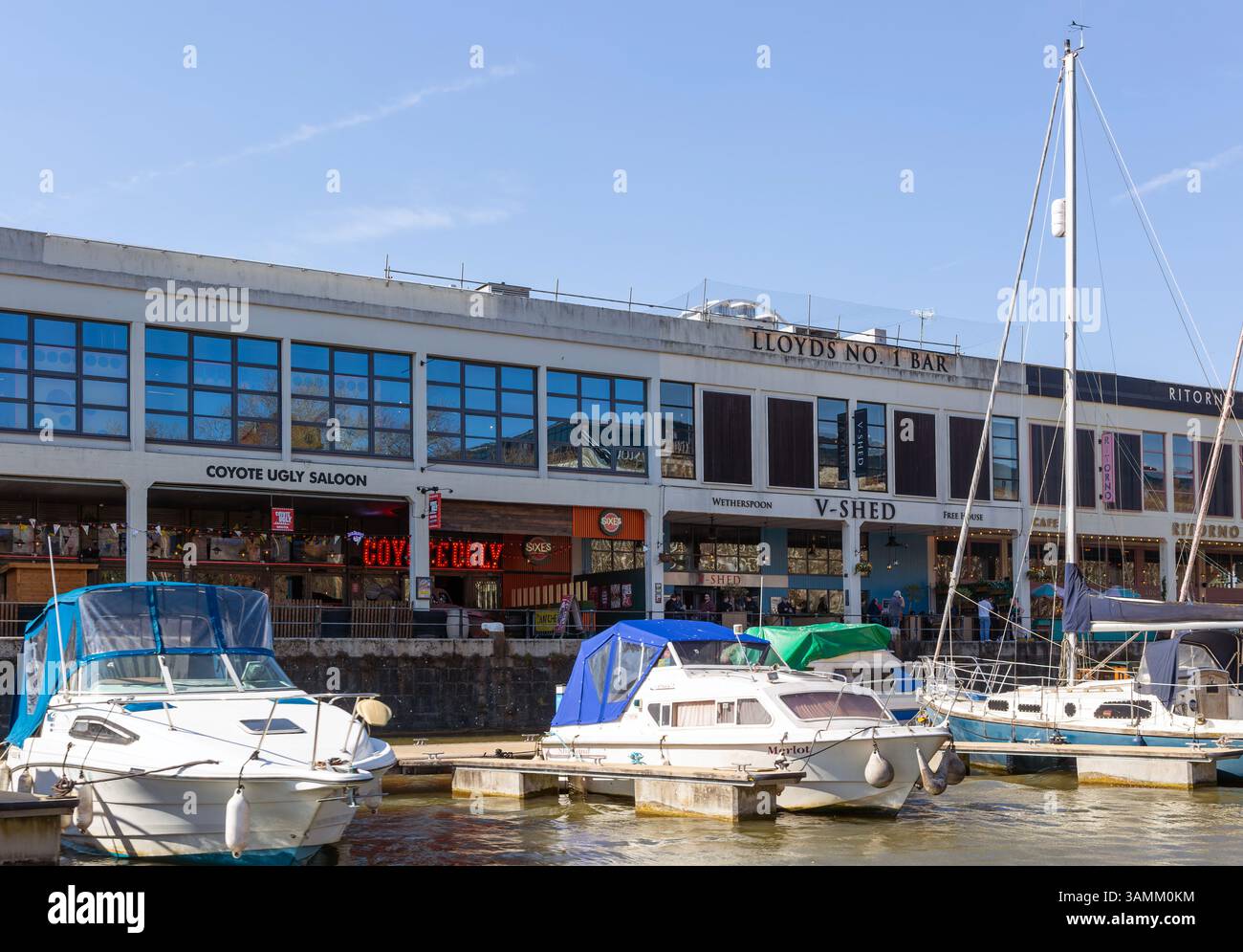 Waterfront bars and restaurants, boats at moorings, view from water ...
