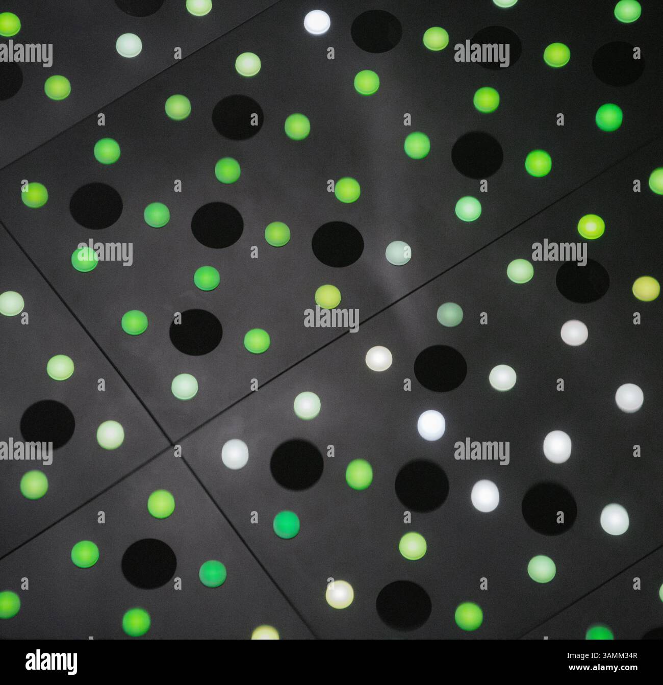Colorful light dots illuminate a textured surface in a contemporary ...
