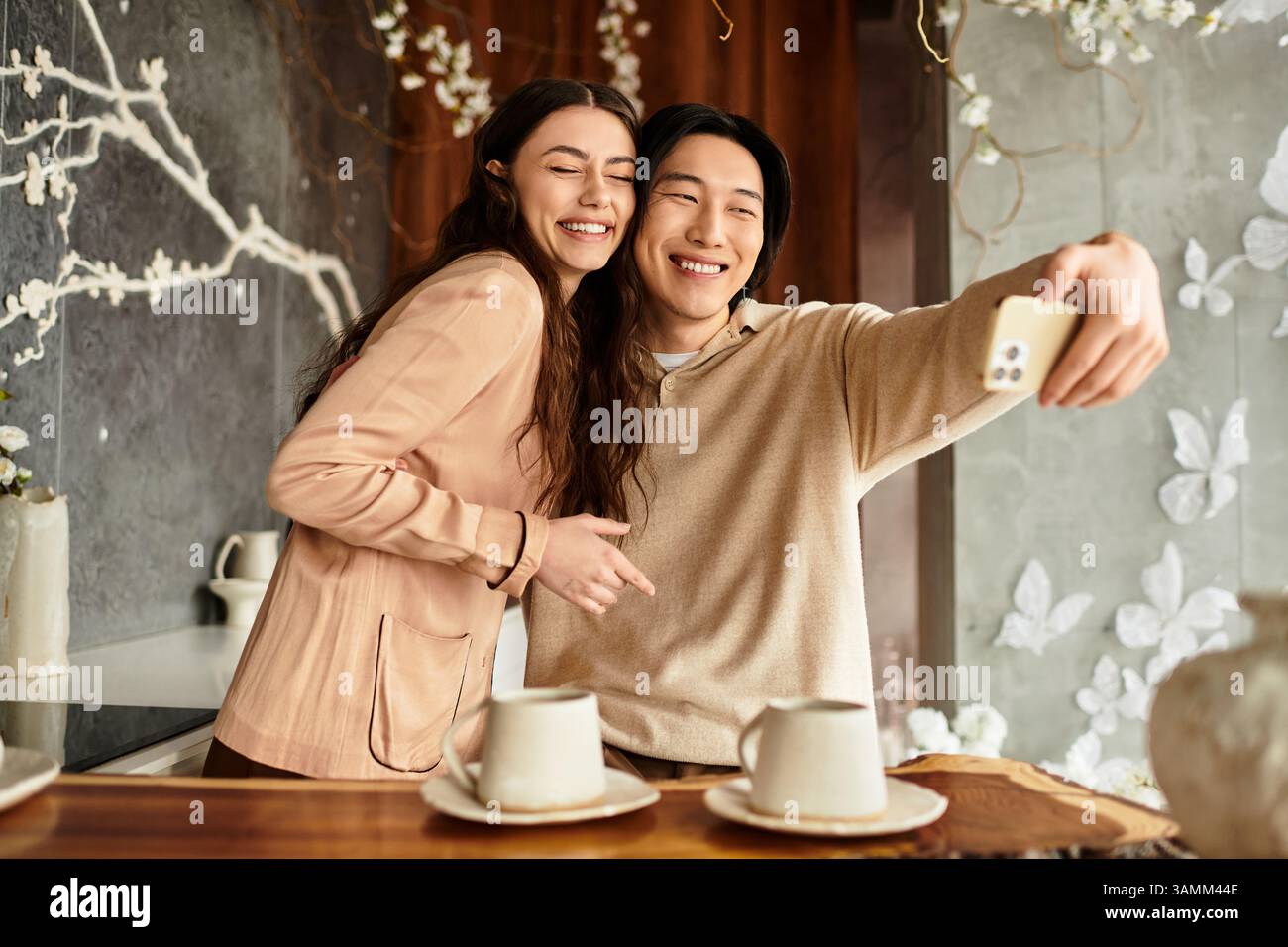 Excited couple sharing smiles as they capture a joyful moment while ...