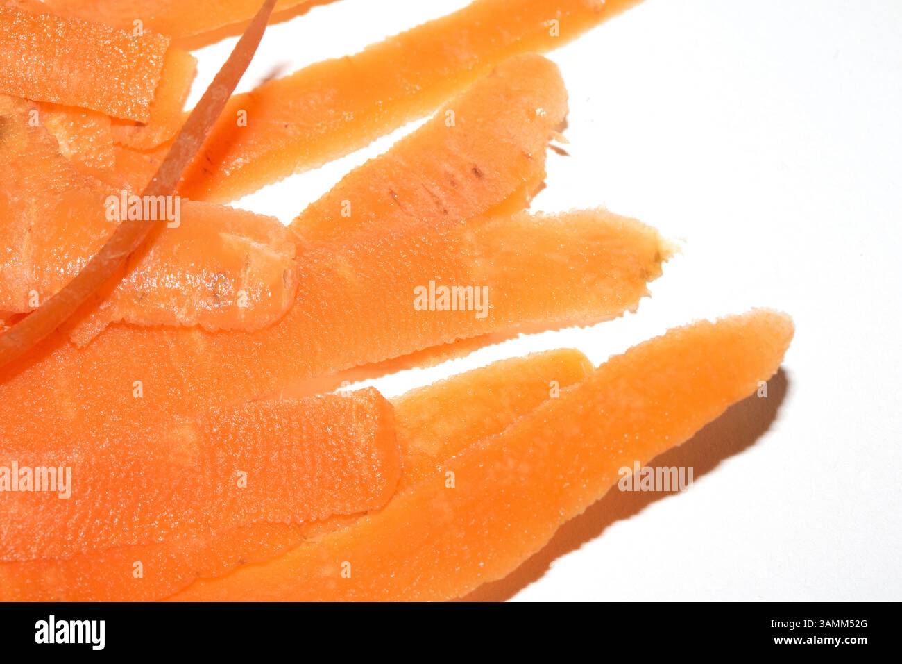 Close up of carrot scrap peelings food waste for compost on white ...