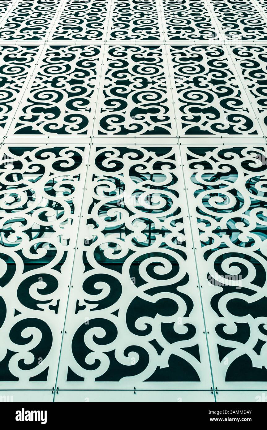 Patterned facade with a repetitive swirling design in architectural ...