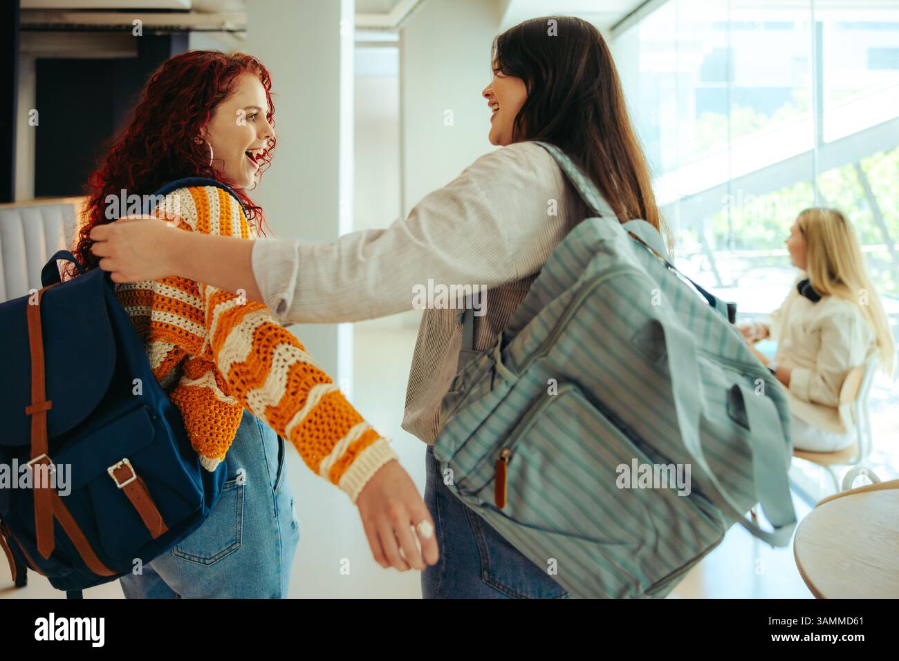 Two happy classmates share a friendly greeting in a bright school ...