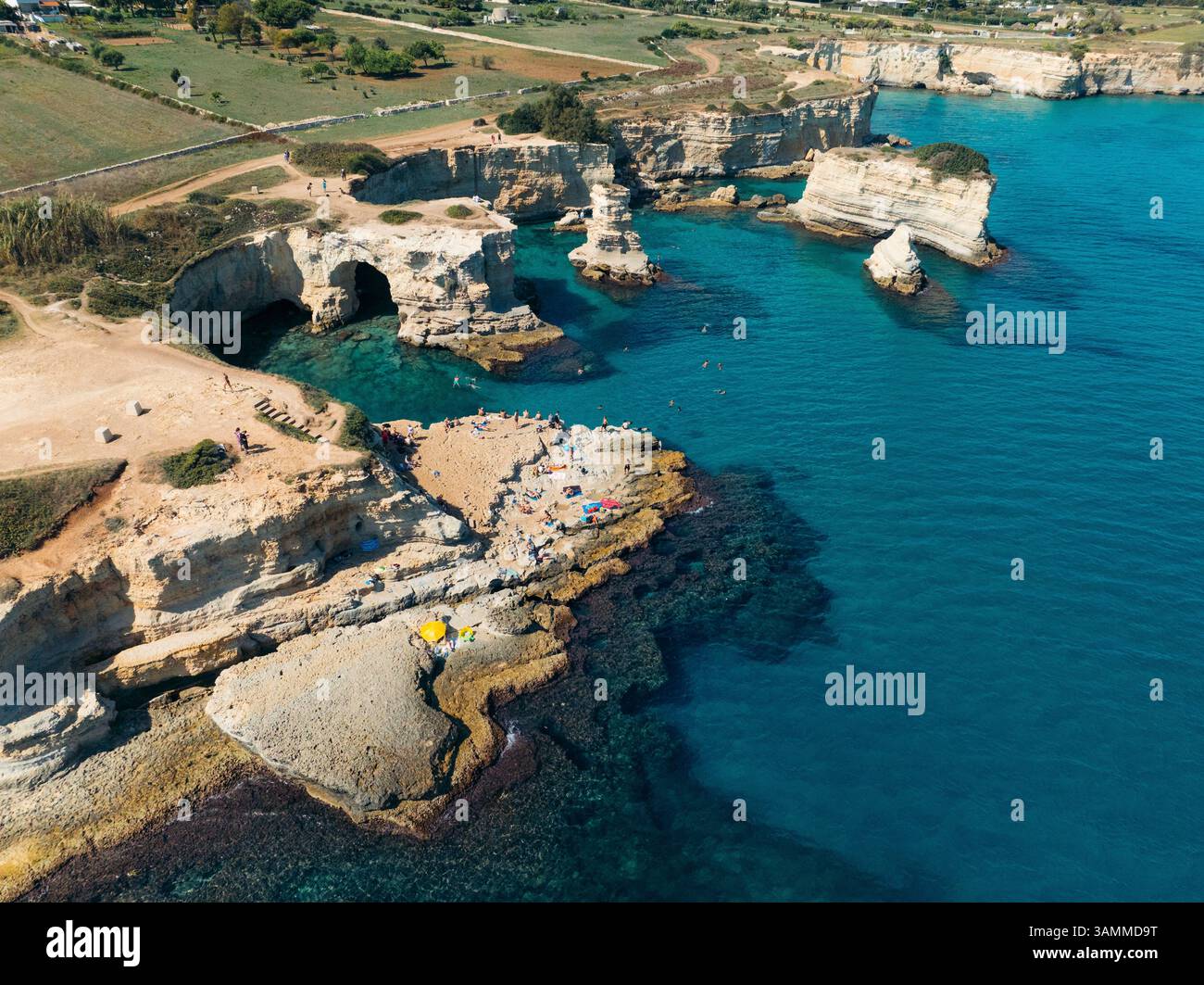 Aerial view of beach Torre Sant'Andrea with rugged cliffs and azure sea ...