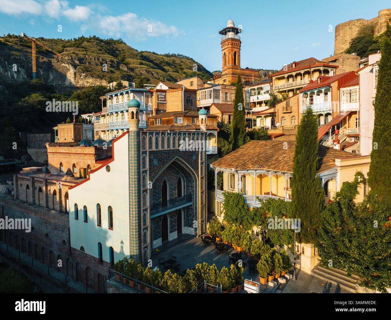 Aerial view of historic stone buildings and a tower amidst greenery and ...