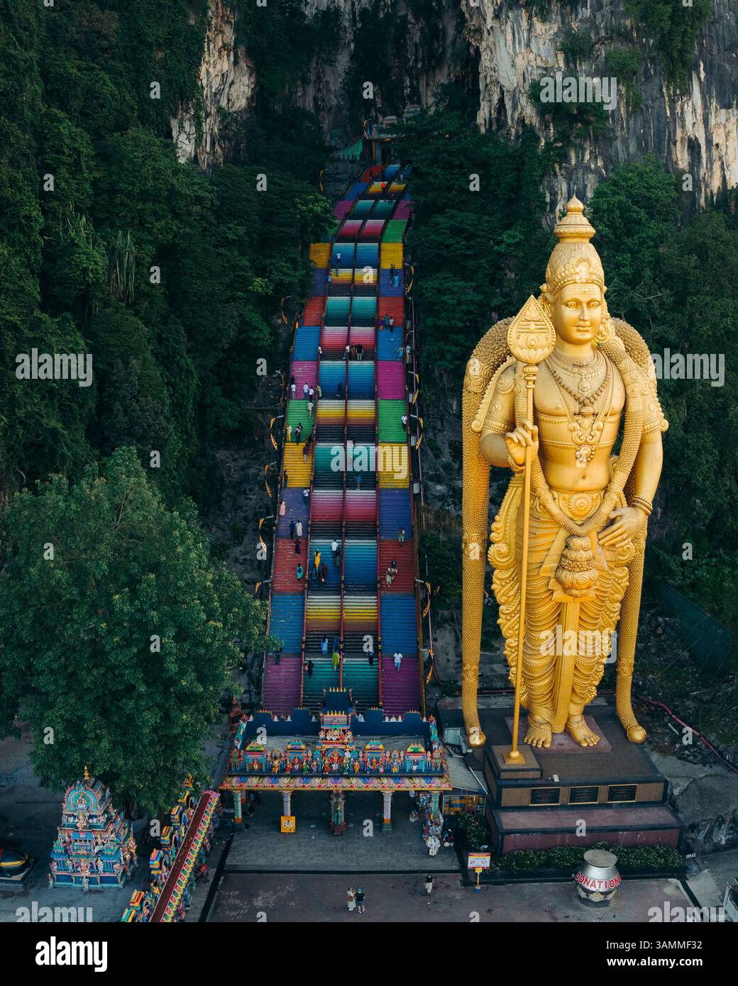 Aerial view of the colorful Batu Caves with the towering statue of ...