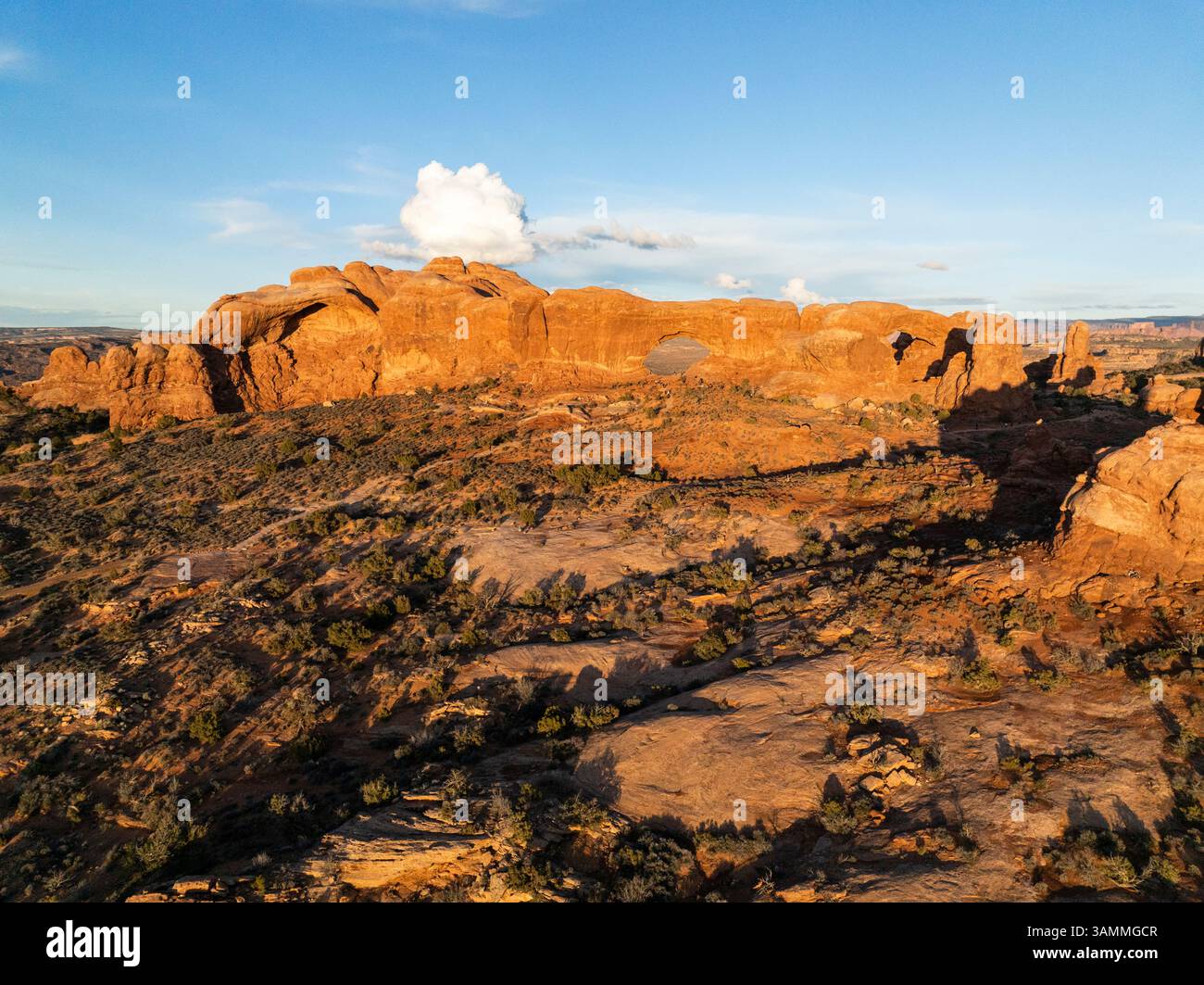 Aerial view of breathtaking rock formations and arches in a vast desert ...