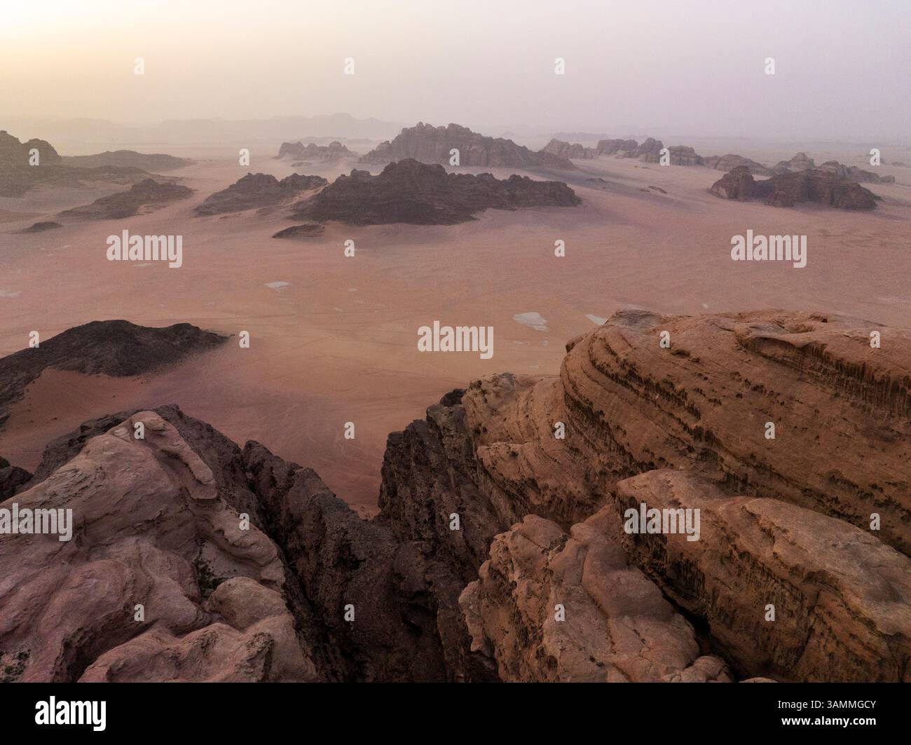 Aerial view of vast arid desert with rugged rock formations and sandy ...