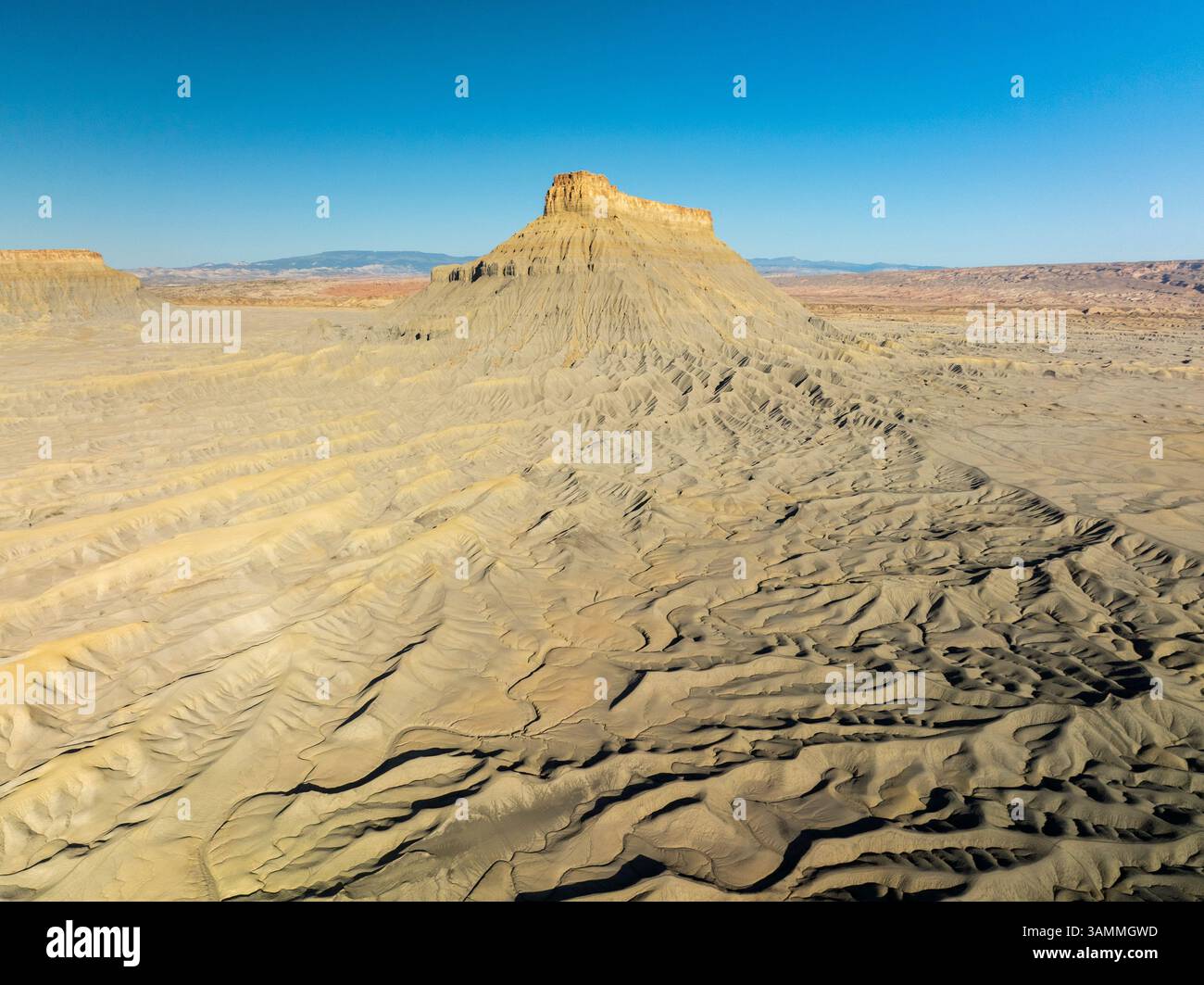 Aerial view of expansive desert landscape featuring a majestic mesa ...
