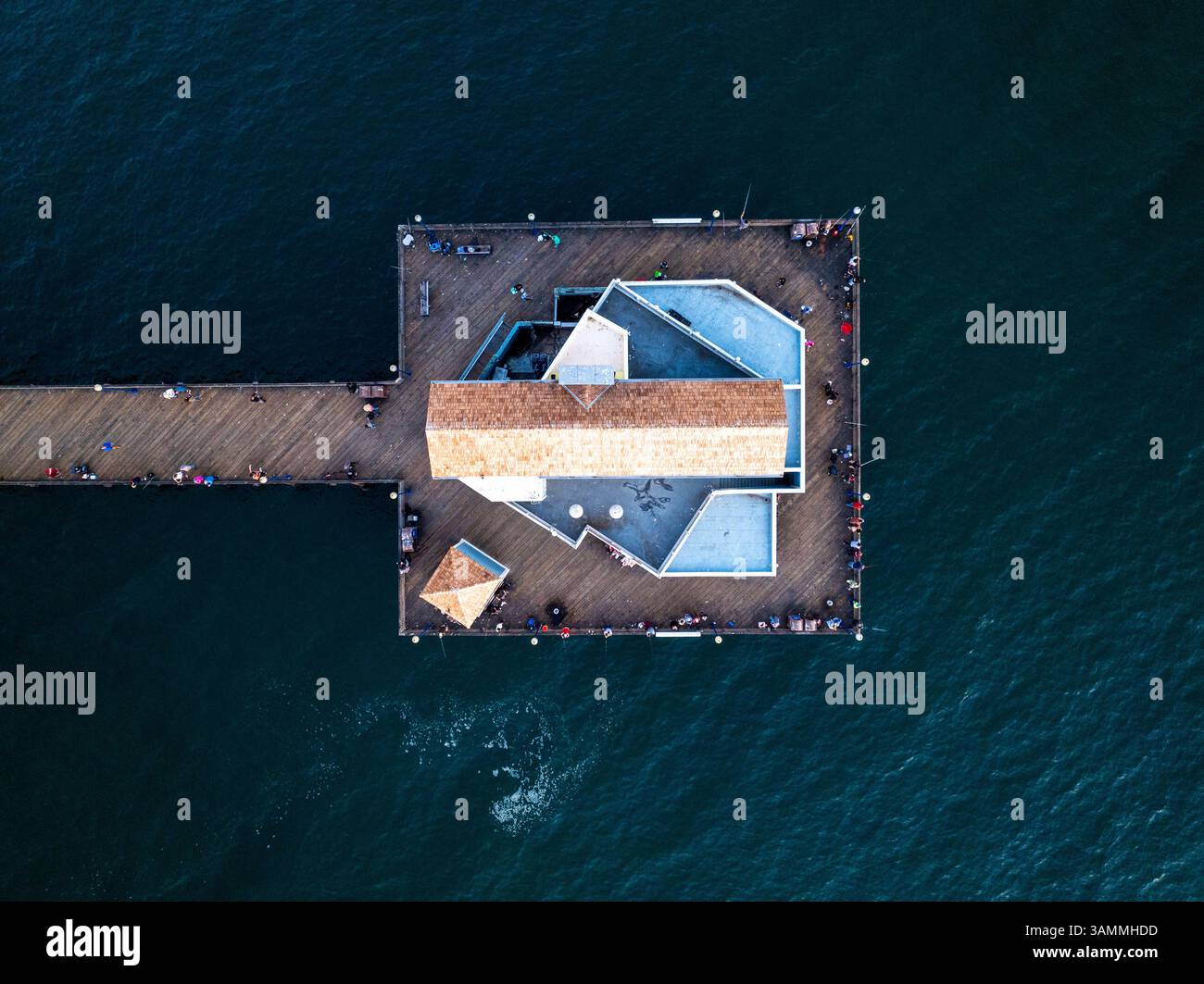 Aerial view of a beautiful wooden pier extending into the ocean with ...