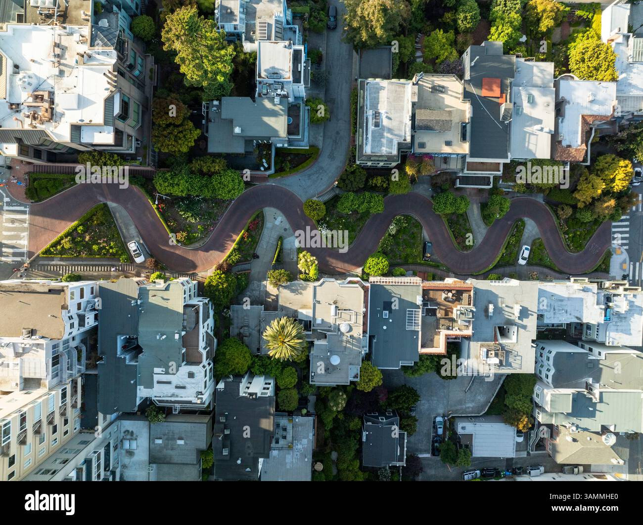 Aerial view of beautiful urban landscape with winding road, buildings ...