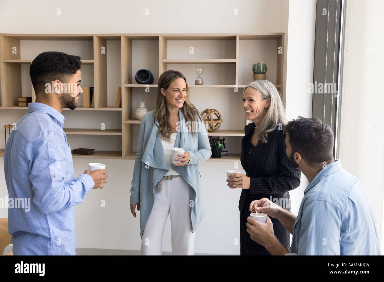 Happy diverse multinational business team friends talk during coffee ...