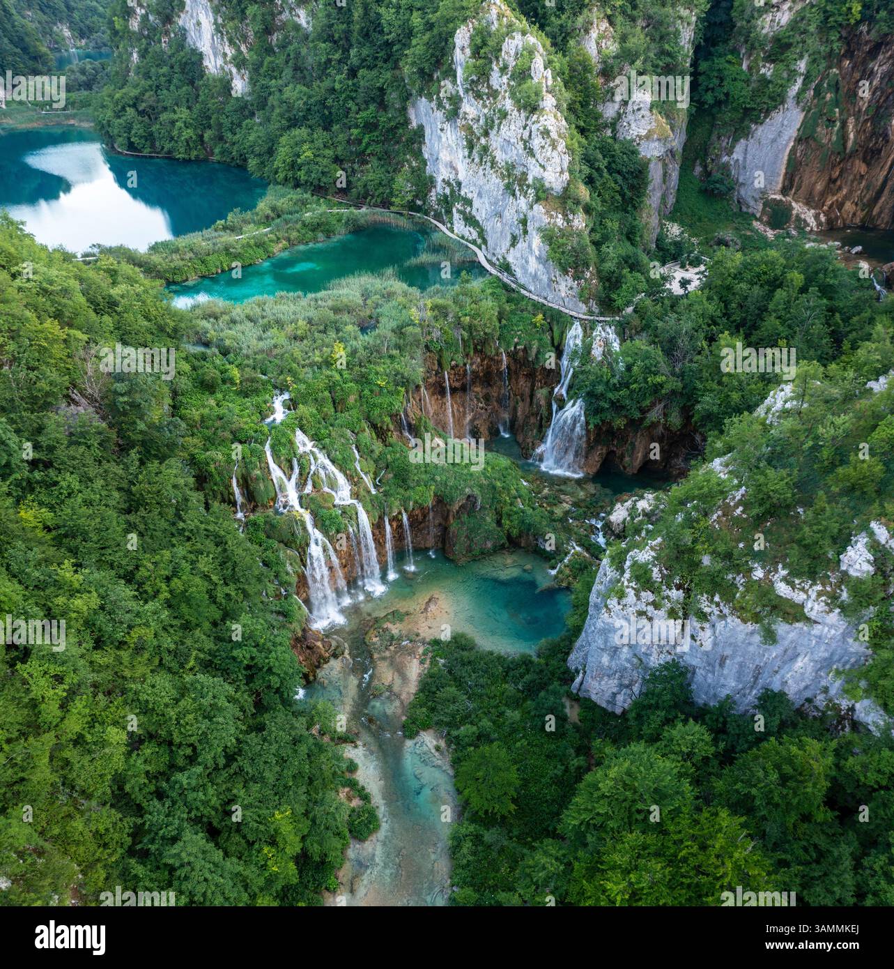 Aerial view of cascading waterfalls and turquoise lakes surrounded by ...