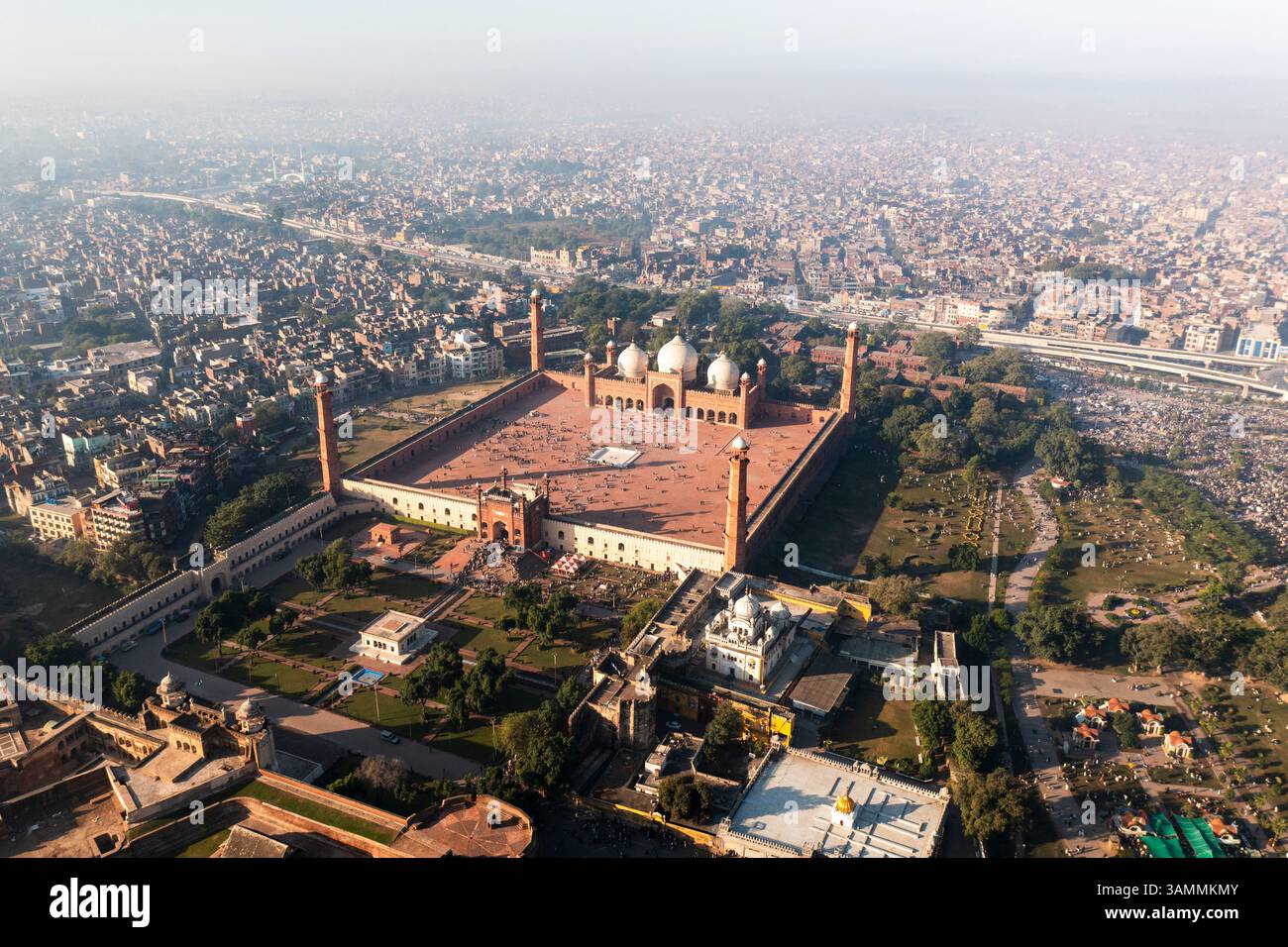 Aerial view of the historic Badshahi Mosque amidst a bustling cityscape ...