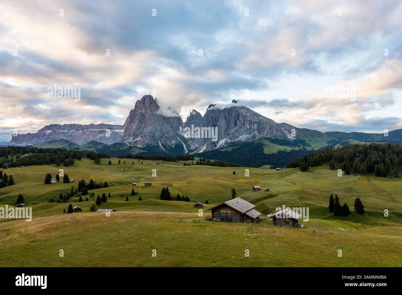 Aerial view of serene and picturesque dolomites with wooden cabins and ...