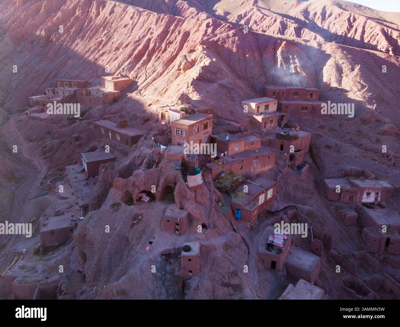 Aerial view of a remote mountain village with traditional adobe houses ...