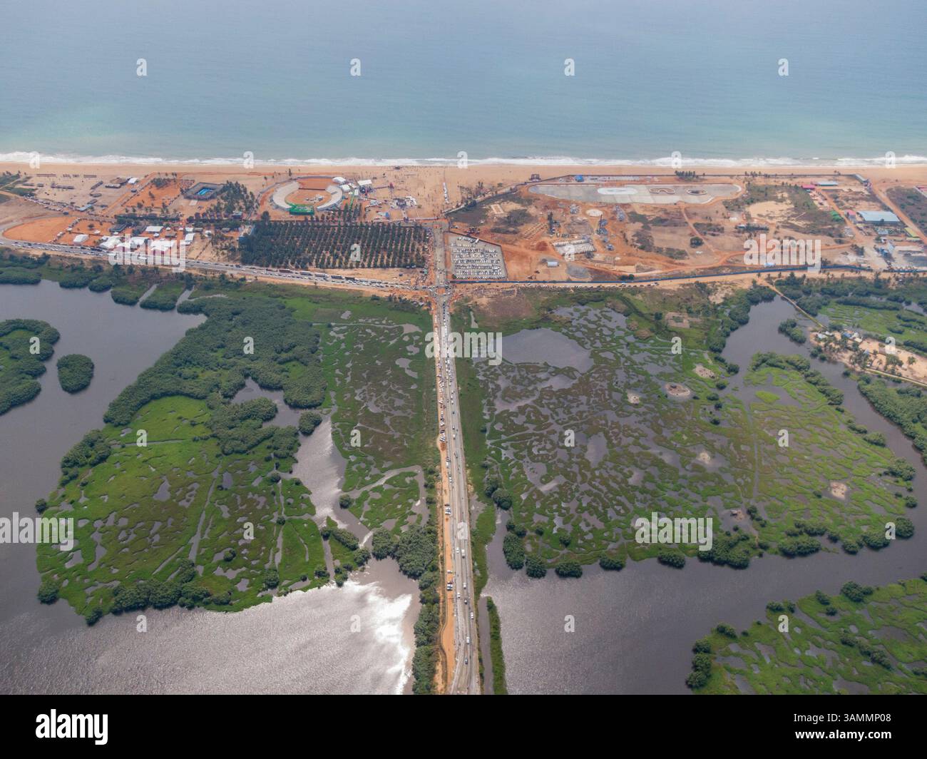 Aerial view of coastal wetlands and urban development along Djegbadji ...