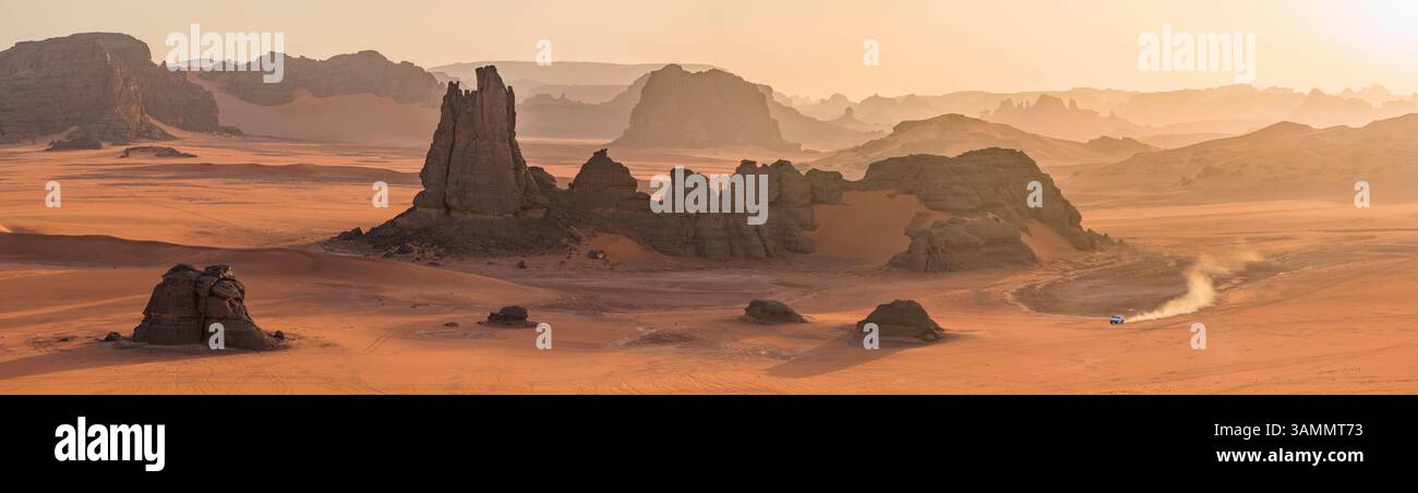 Aerial View of rock formations among sand dunes at sunset in the Sahara ...