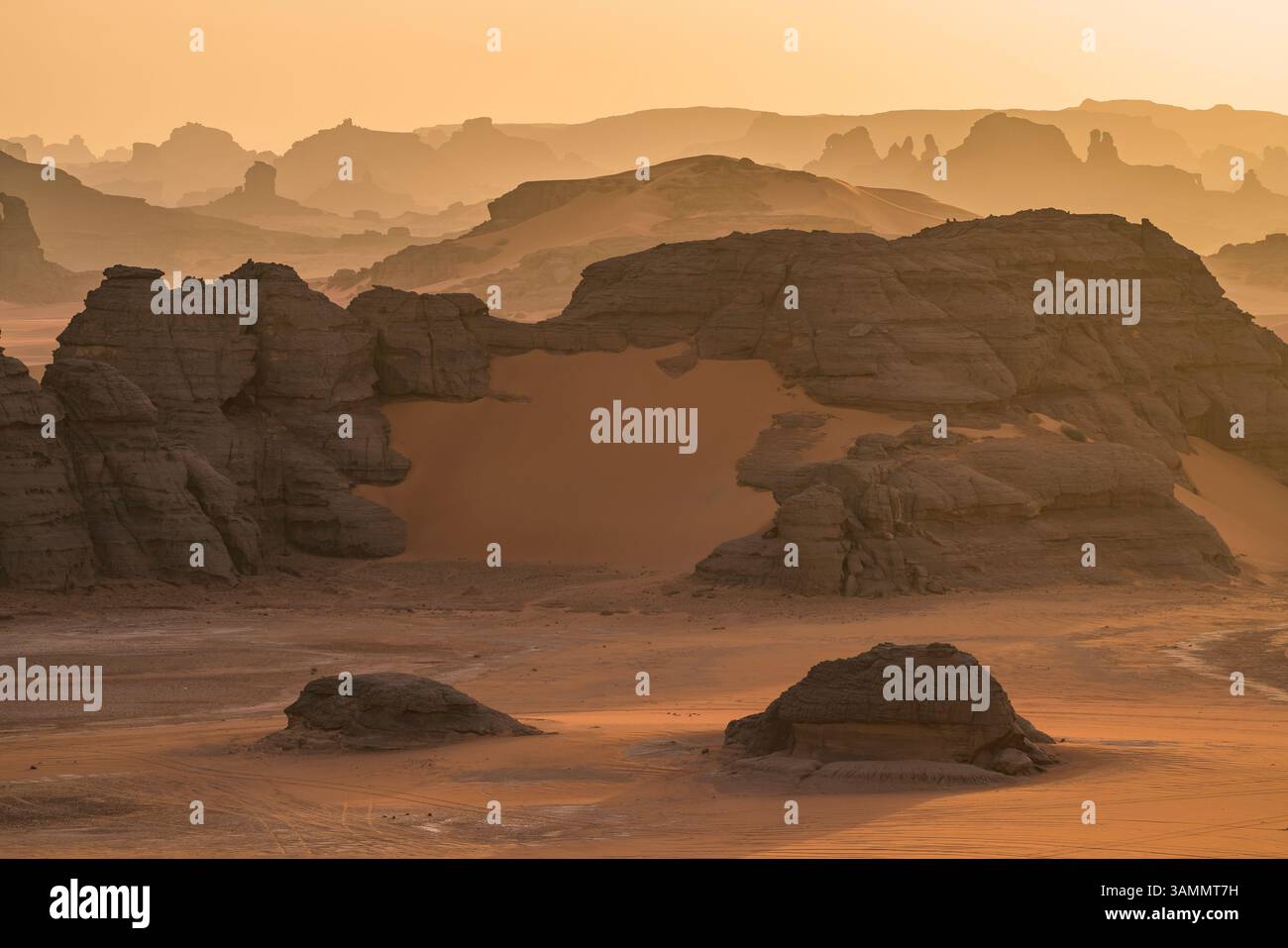 Aerial View of rock formations among sand dunes at sunset in the Sahara ...